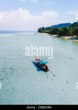 Tourist boat and Turqouse colored ocean and white beach at the tropical ...