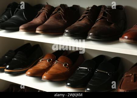 White shelving unit with different leather shoes Stock Photo - Alamy