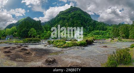 Panoramic view of Furnas Lake surrounded by grass and trees under a ...