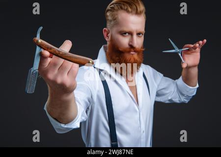 Hairdressing skills of man. Retro hairdresser holding razor and ...