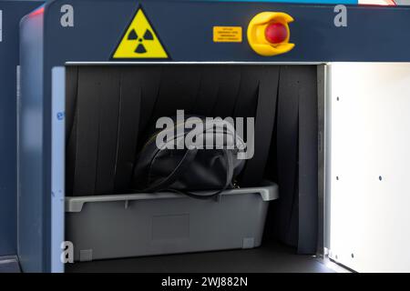 Close-up of scanning travel baggage with x-ray scanner at airport ...