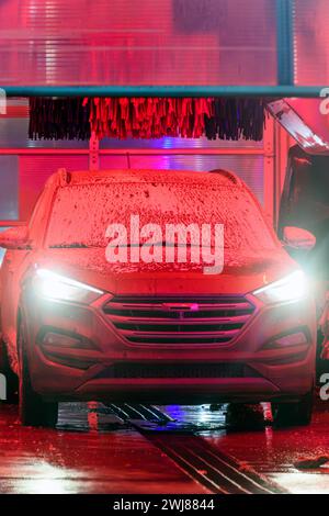 Car Automatic Wash at Night. Modern Vehicle During Washing Process ...