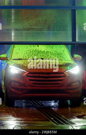 Automatic car wash exit overhead door at night Stock Photo - Alamy