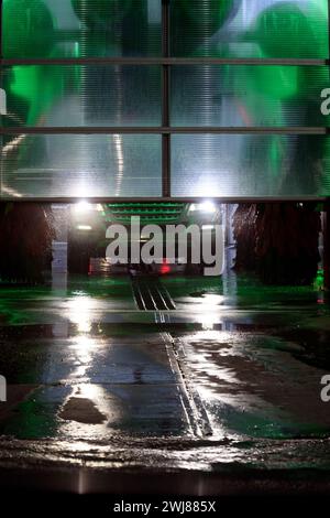 Automatic car wash exit overhead door at night Stock Photo - Alamy