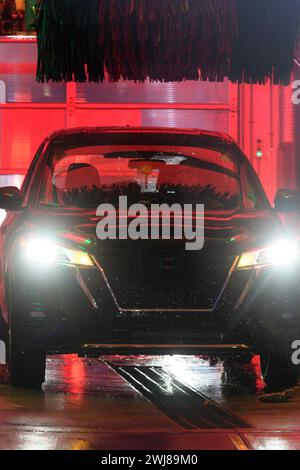 Automatic car wash exit overhead door at night Stock Photo - Alamy