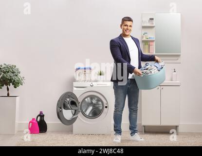 Portrait of young man washing clothes by hand Stock Photo - Alamy