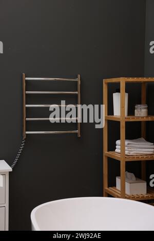 Interior of cozy bathroom with shelving unit and laundry basket Stock ...