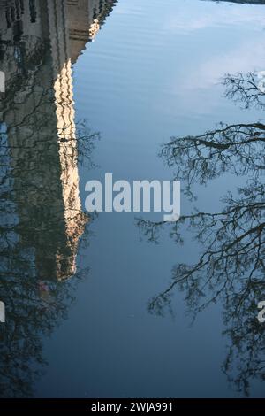 The Italianate tower of New Mill, Saltaire, reflects in the waters of ...