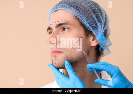 Young man with marked face receiving injection on green background ...