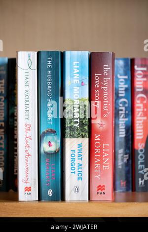 Novels paperback books bookshelf Stock Photo - Alamy
