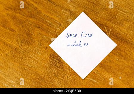 Self care o'clock message handwritten on post it Stock Photo - Alamy