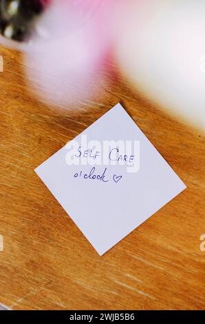 Self care o'clock message handwritten on post it Stock Photo - Alamy