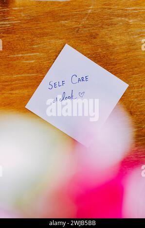Self care o'clock message handwritten on post it Stock Photo - Alamy