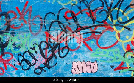 A Collection Of Multicoloured Graffiti Tags Spray Painted On A Concrete ...