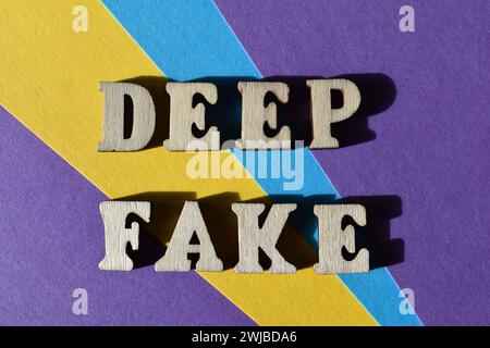 Deep Fake, words in wooden alphabet letters isolated on pink and yellow ...