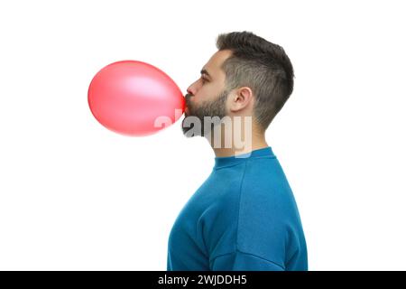 Man inflating bright balloon on violet background Stock Photo - Alamy