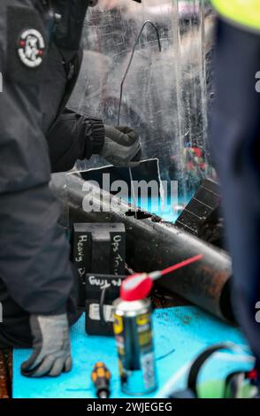 Specialist police officers from the cutting team go about removing the ...