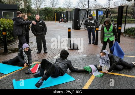 Protesters place themselves in a three-way lock-on, blocking the ...