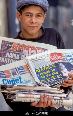 Boy selling newspapers on street, New York City Stock Photo - Alamy