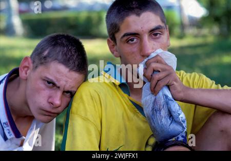 Romania, Bucharest, homeless glue sniffers in a city park try to forget ...
