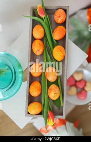 Composition with white tulips and Easter eggs on wooden background ...