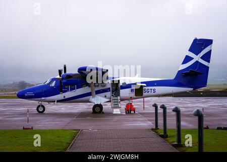 A Loganair Twin Otter aircraft parked on the runway after arrival at ...