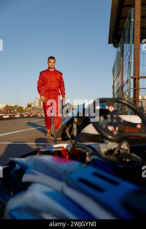 Go-kart driver walking to car before race at starting line Stock Photo ...