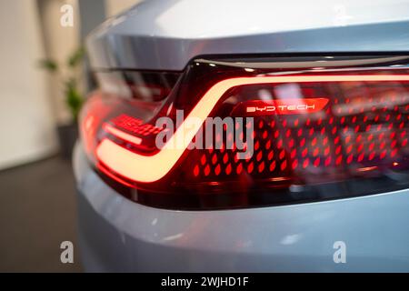 close-up glowing logotype BYD on red taillight, grey BYD Seal U 2024 ...