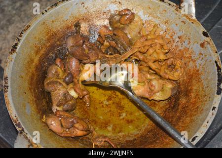 Photo of chicken being cooked on a cauldron Stock Photo - Alamy