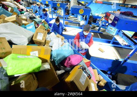 Express workers sort parcels on an assembly line at an e-commerce ...