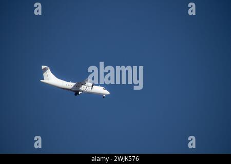 Large airplane preparing the landing with a blue sky Stock Photo - Alamy