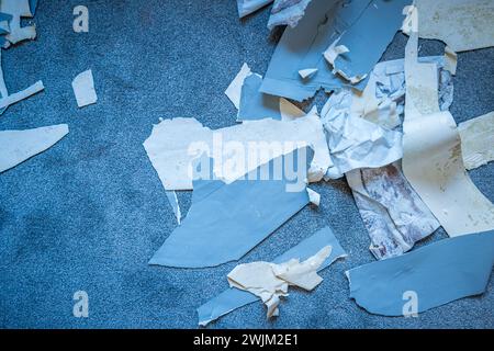 Stripped wallpaper pieces laying on floor during room renovation in ...