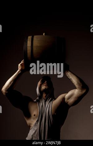 Strong man hold wooden barrel on black. Oktoberfest. Brewer man ...