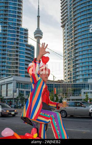 Street artists inflating animal balloons in downtown district, Toronto ...