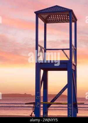 wooden lookout tower, golden hour in swamp lake, lakeside reeds and ...