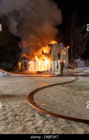Fire fighters tackling fire, house on fire in icy and snowy Oslo ...
