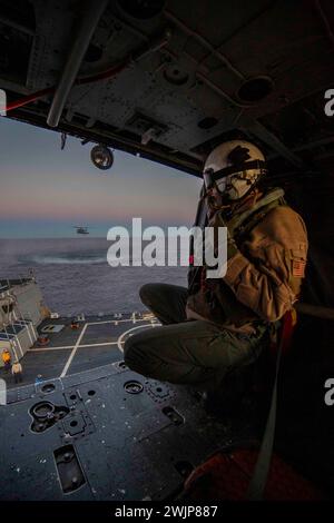Naval Air Crewman (Helicopter) 1st Class John Kainoa, assigned to the ...