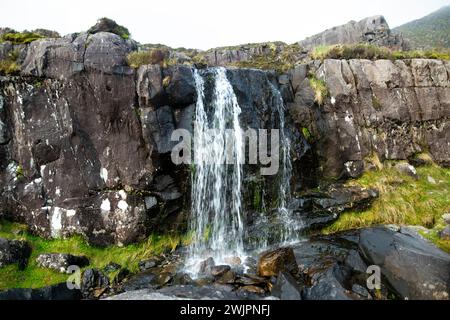 Small waterfall at the Conor Pass, one of the highest Irish mountain ...