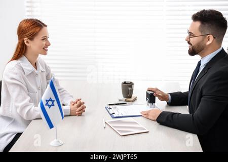 Immigration to Israel. Embassy worker approving visa application form ...