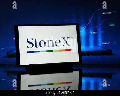 In this photo illustration, a StoneX Group Inc. logo seen displayed on ...