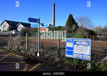 Signs at Totnes railway station and the chimney of the disused Dairy ...