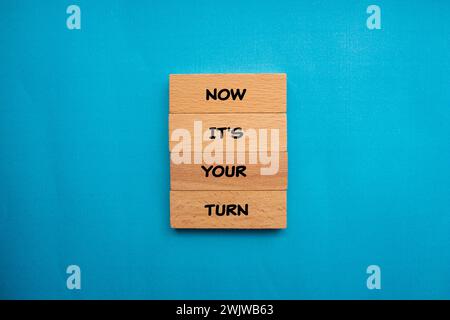 Now it's your turn words written on torn yellow paper with purple ...