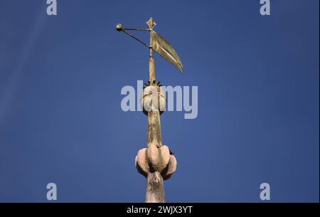 Antique compass rooftop symbols against a blue sky n Turckheim, Alsace ...