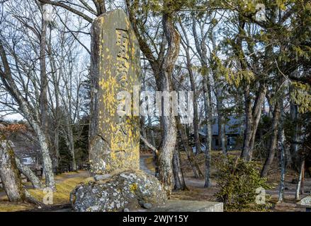 Stone memorials in the forest for the deceased at a shrine. Nagano ...