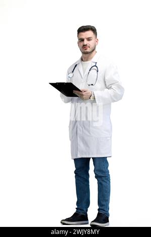 The doctor, in full height, on a white background, shows the heart ...
