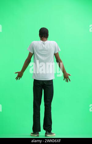 Back view of shocked and scared young man. Hold hands upwards. Rear ...