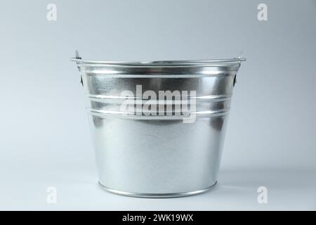 One shiny metal bucket on white background Stock Photo - Alamy