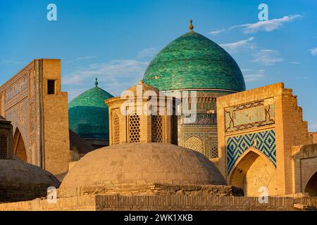 The green domes in Mir i Arab (Emir Alim Khan) Madrasa in Bukhara evoke ...