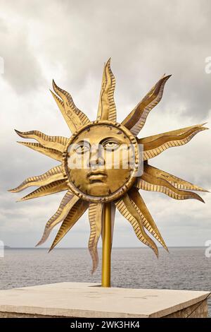 Apollo by Jeff Koons, Hydra, Greece, a large golden sun atop a small ...