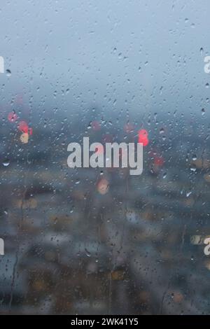 A photograph of London cityscape through a window covered in raindrops ...